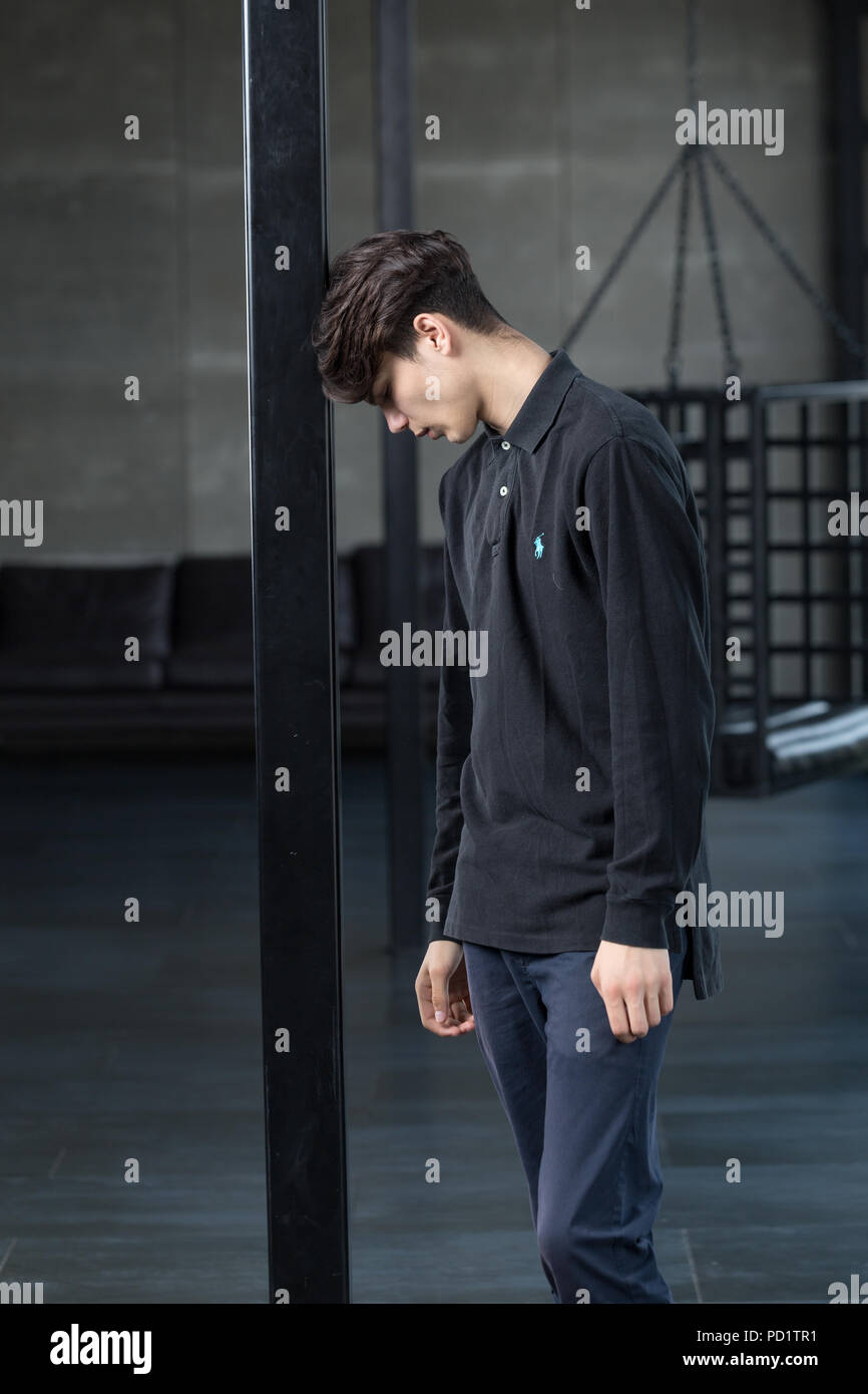 Sad handsome slim young guy head looking down Stock Photo - Alamy
