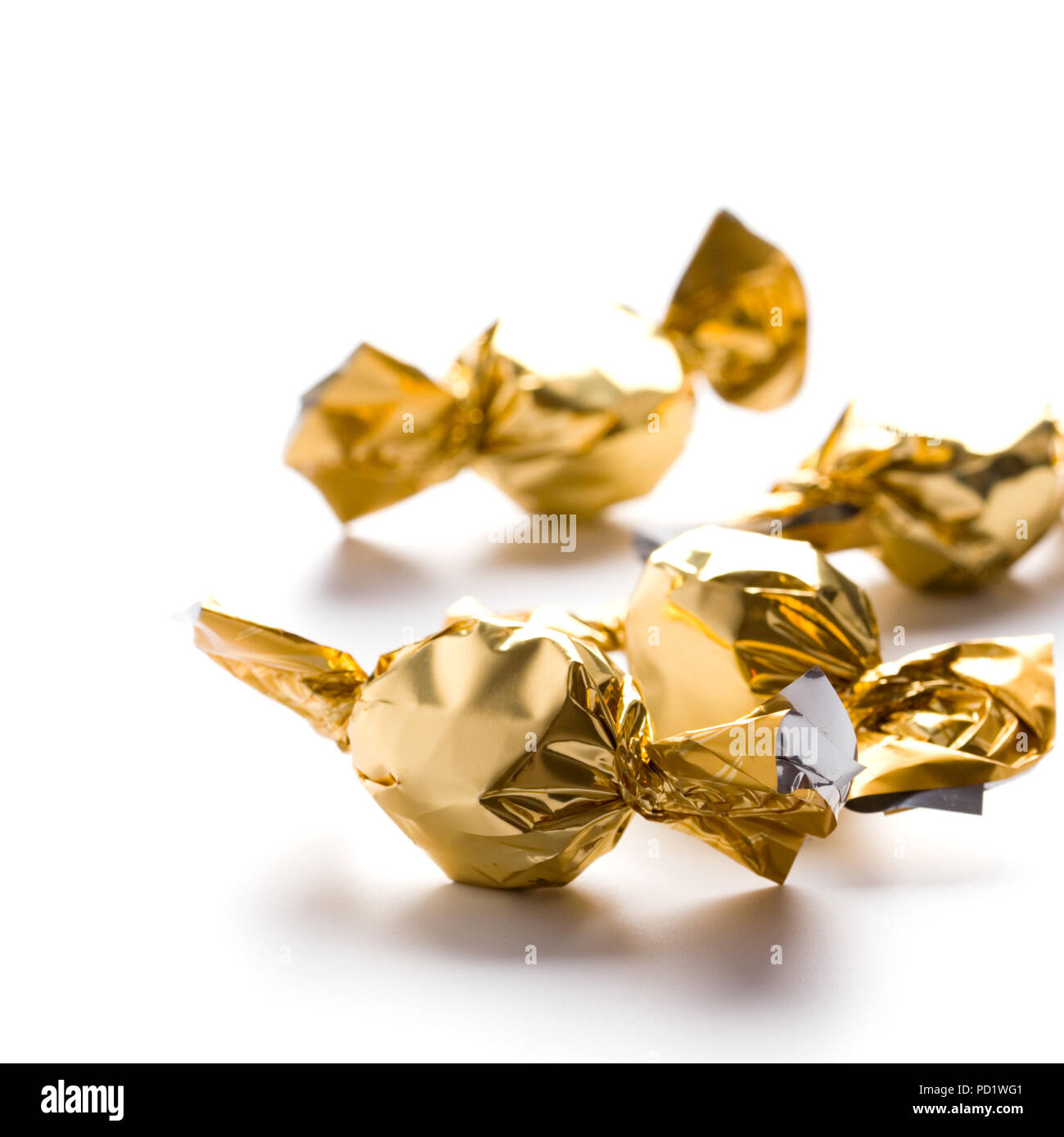 golden sweets closeup on white background Stock Photo - Alamy