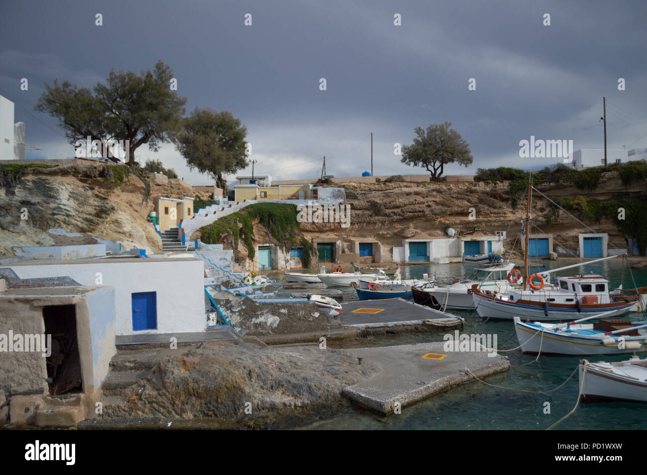 Bay of Mandrakia with Traditional Greek Fishermen Garages and Boats in ...