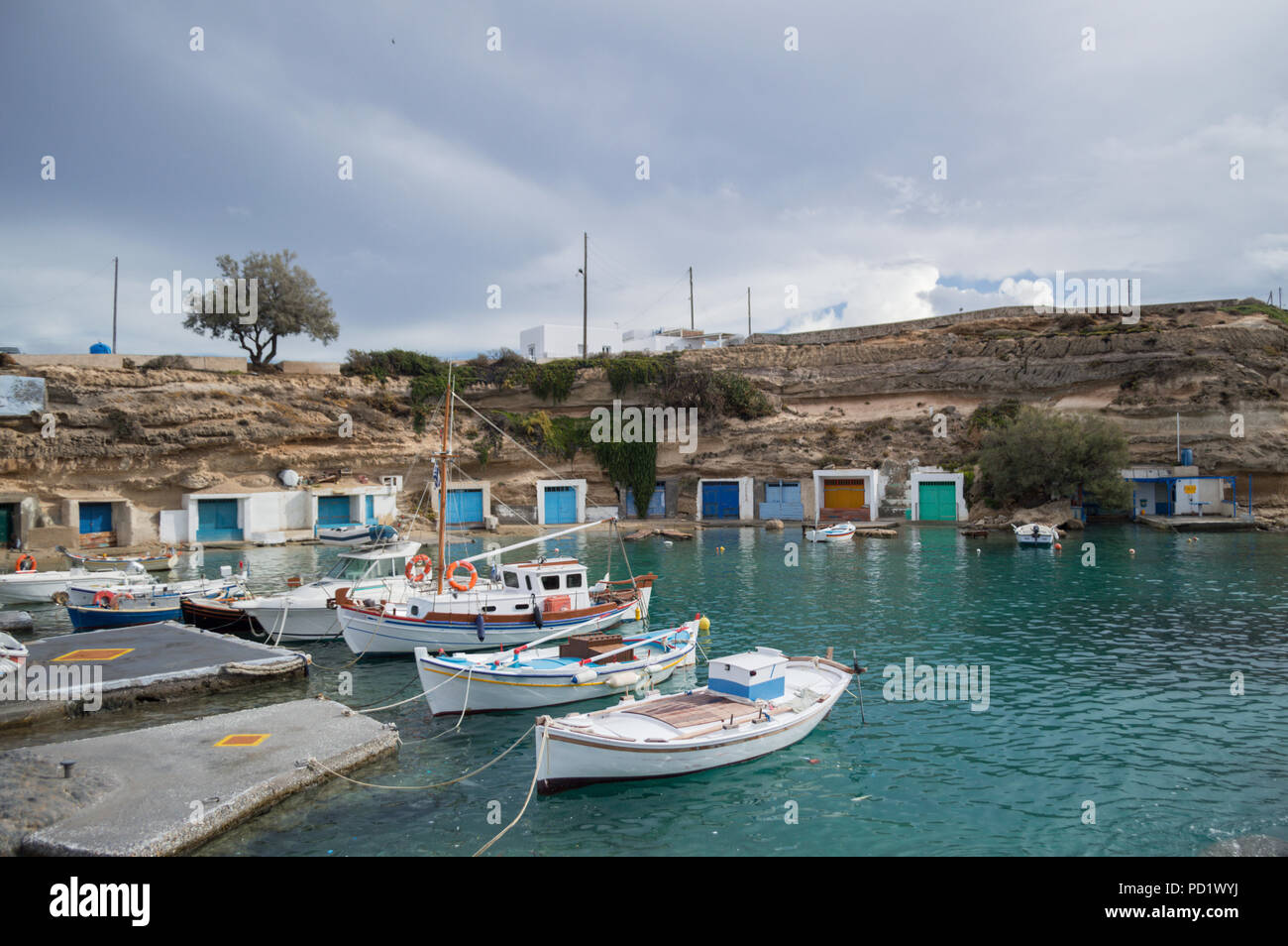 Bay of Mandrakia with Traditional Greek Fishermen Garages and Boats in ...