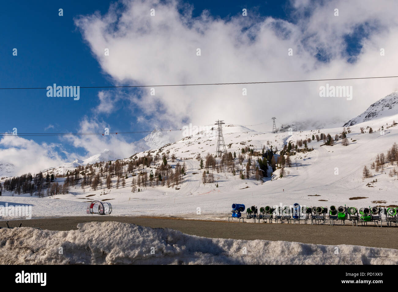 Ski resort in Bernina alps with a lot of snowcannons and with a blue ...