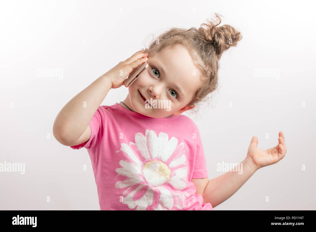 smiling adorable kid is using the smart phone. hobby, children ...