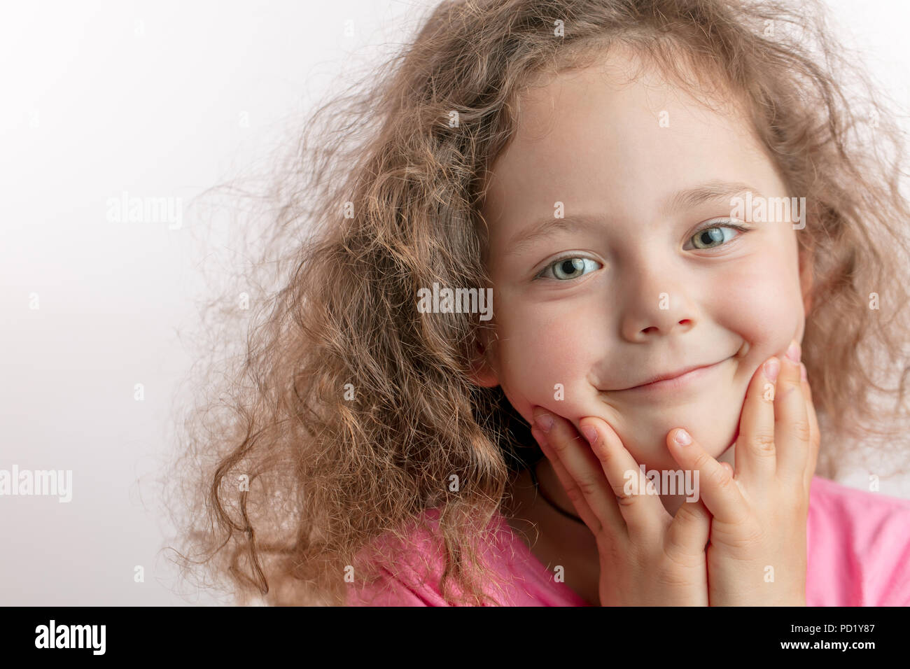 smiling beautiful ginger kid posing to the camera. close up cropped ...