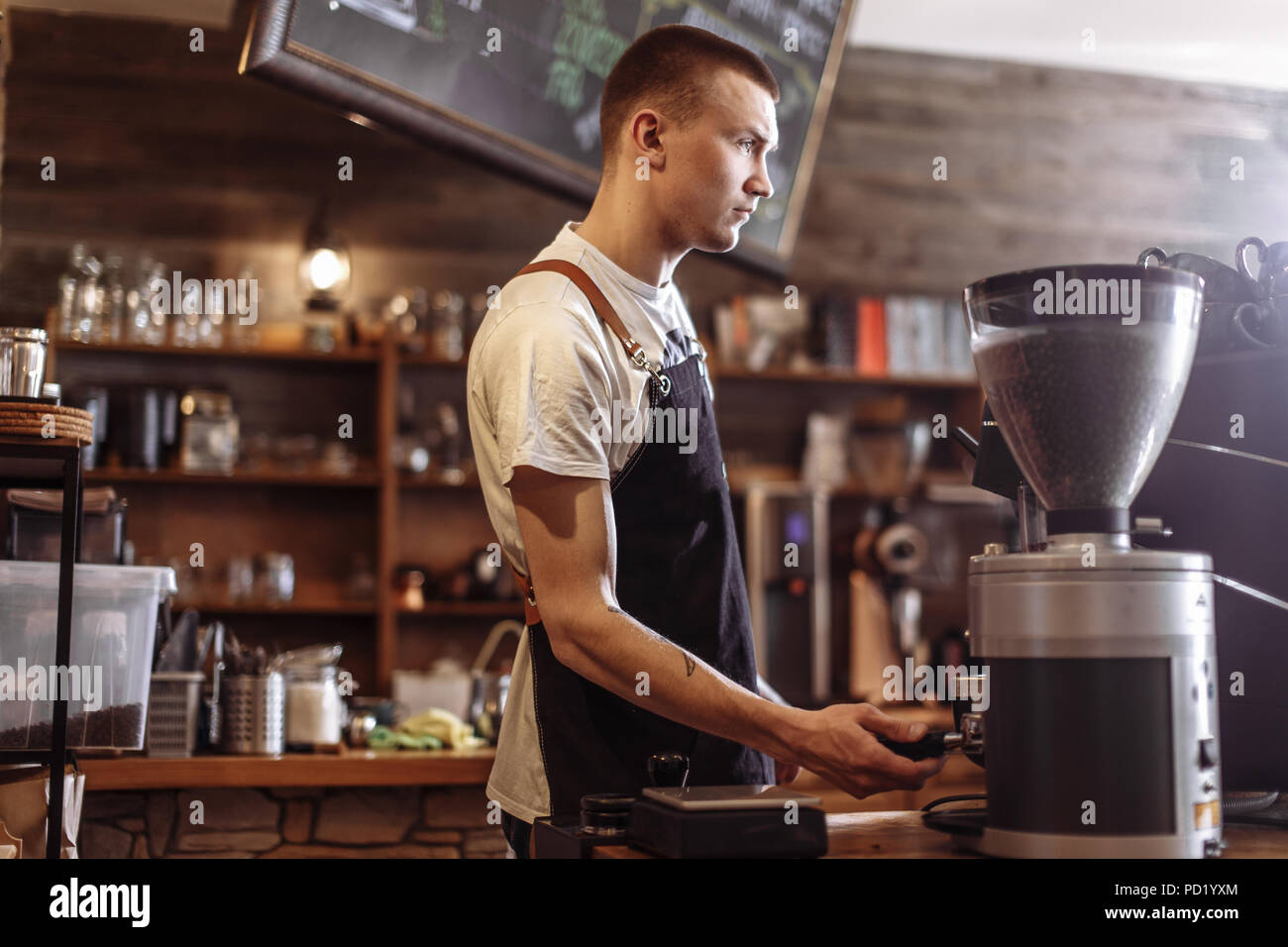 a hardworking attractive barista at workplace. occupation concept. side ...