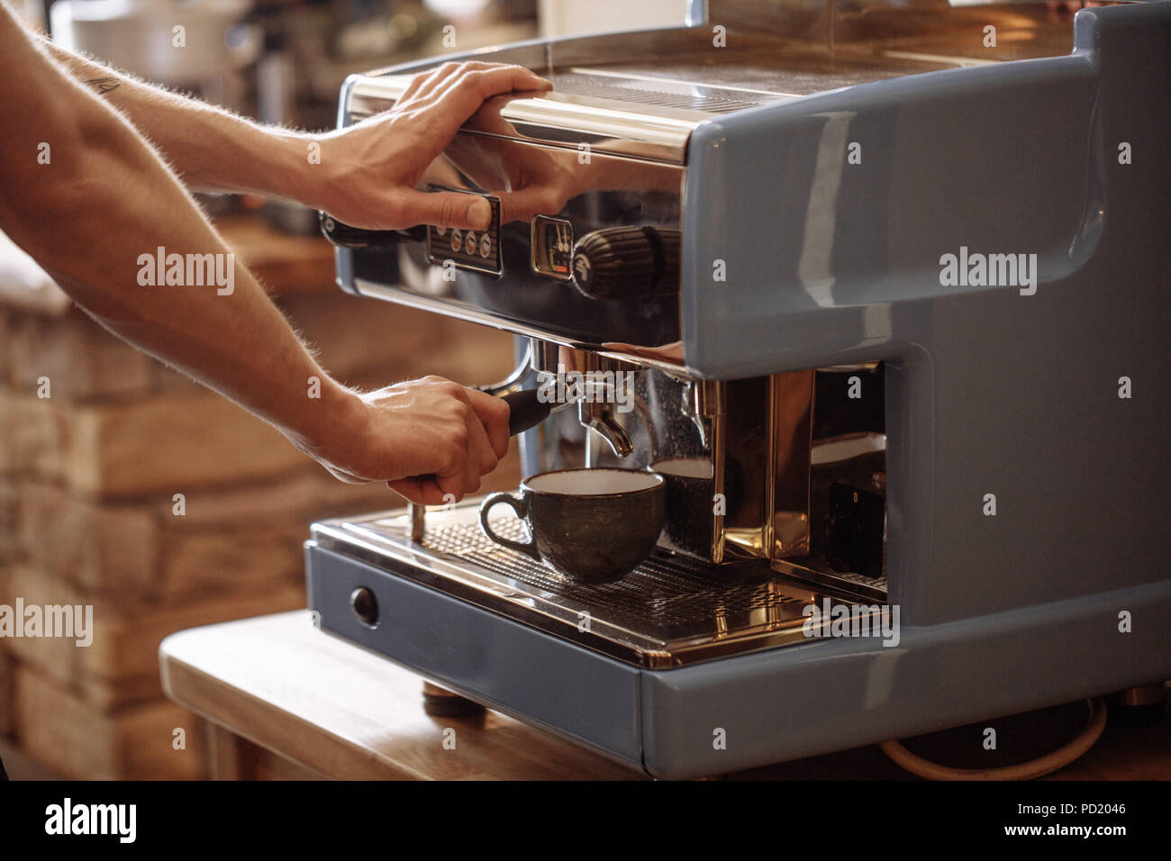 electric model of coffeemaker.man is checking the coffee machine. close ...