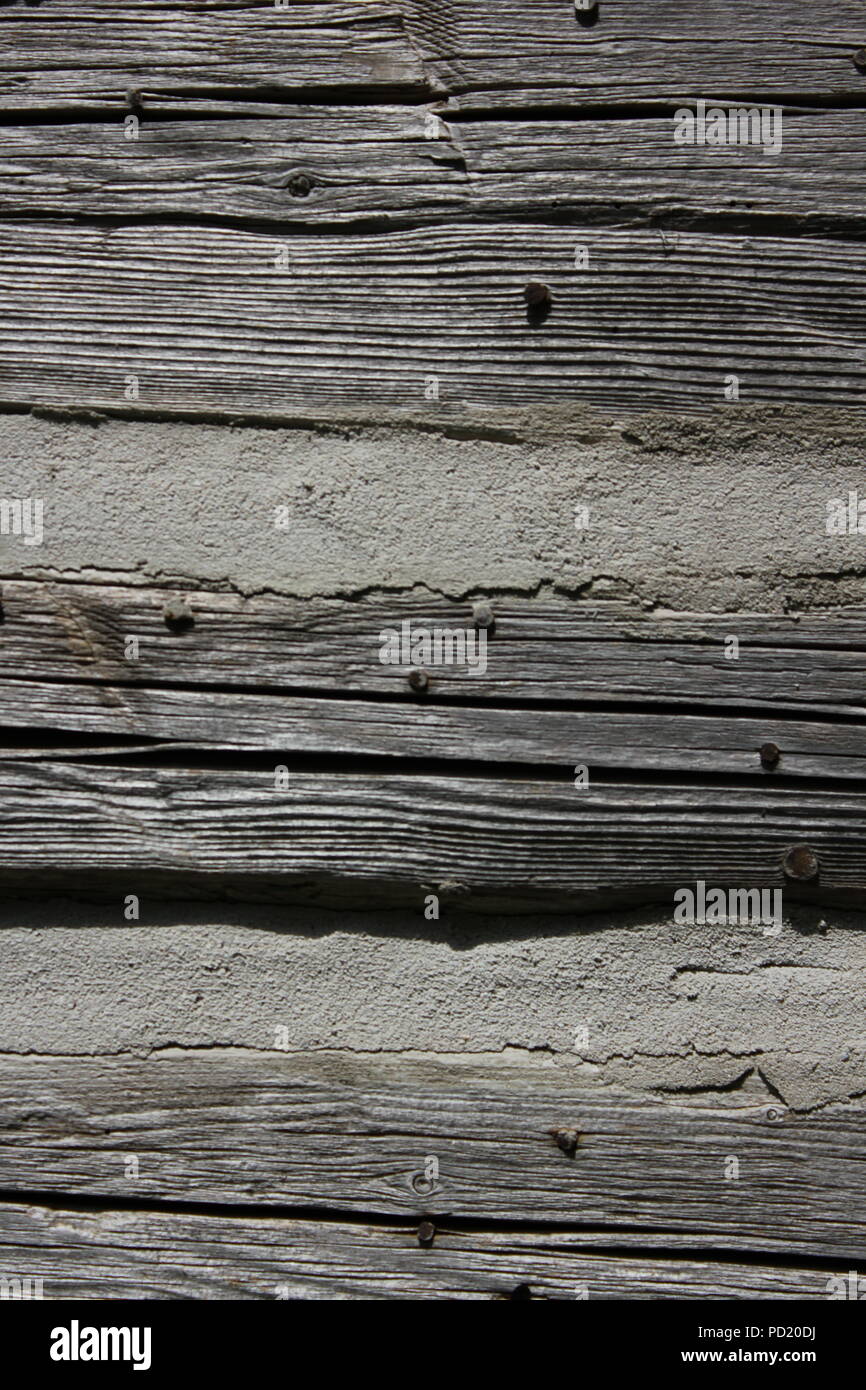 A full frame closeup view of a log cabin construction with mud infill ...