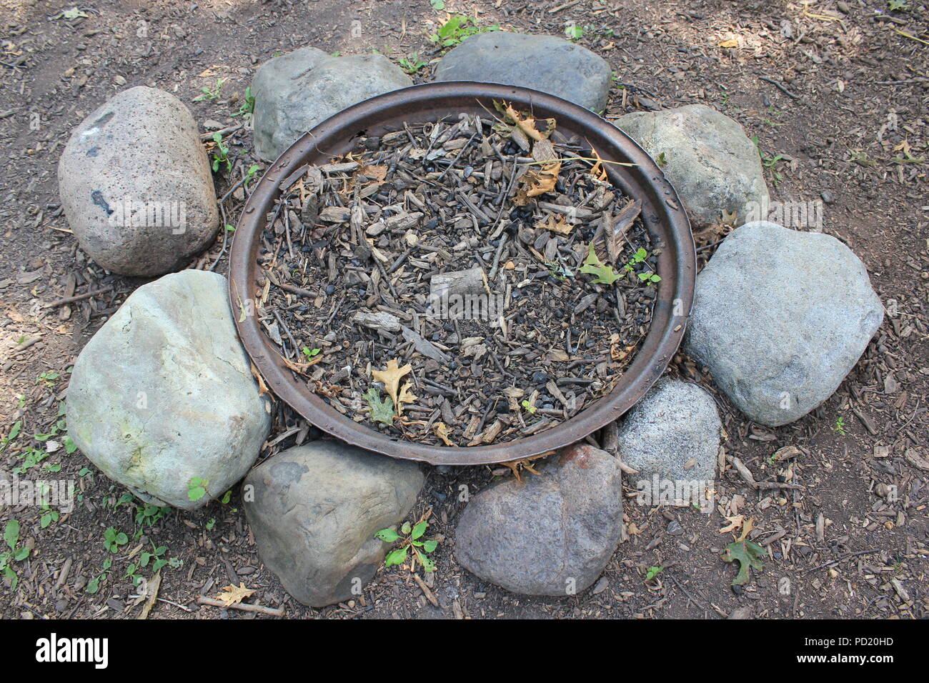 Traditional rustic campfire surrounded by huge rocks and boulders Stock ...