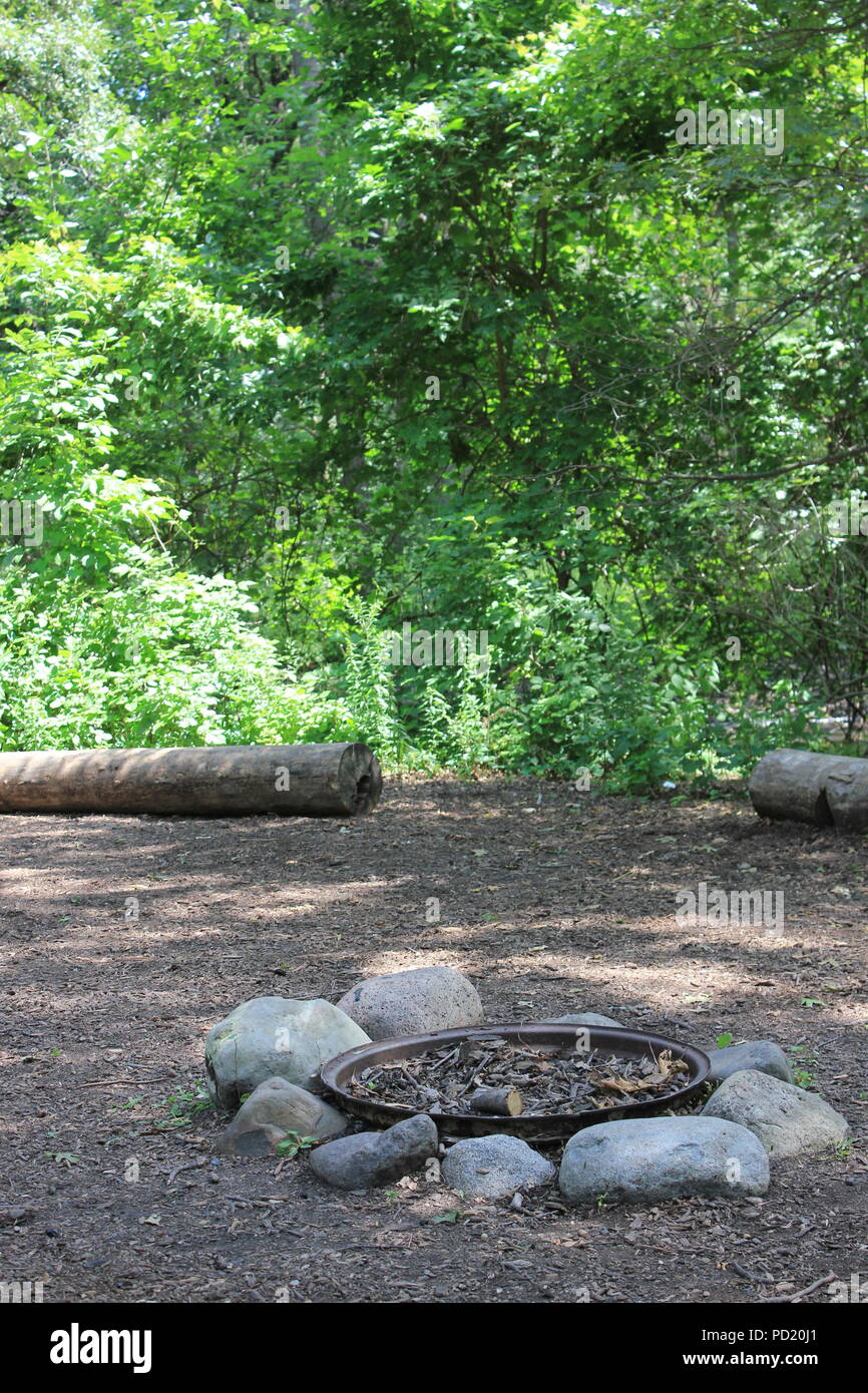 Traditional rustic campfire surrounded by huge rocks and boulders Stock ...