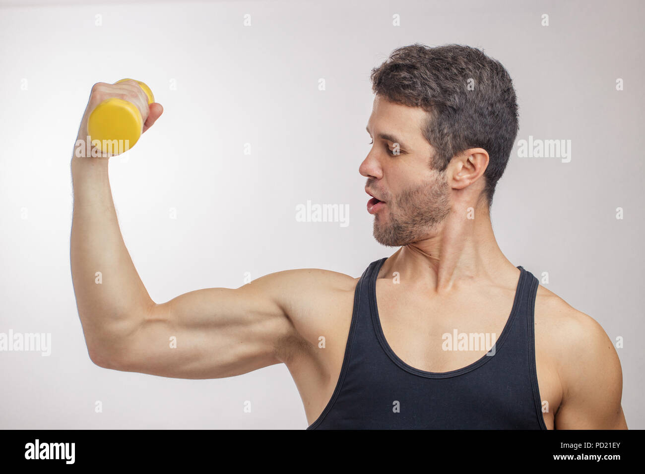 close up side view portrait of strong man showing his muscle. sporty ...
