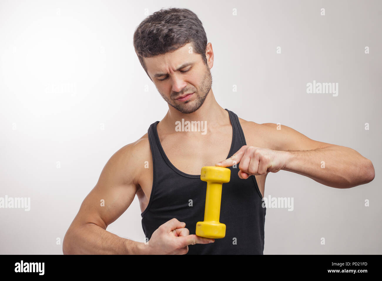hardworking man is holding dumbbell with fingers Stock Photo - Alamy