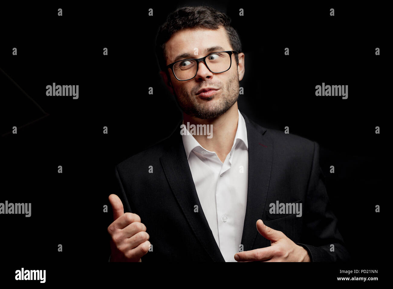 young funny man looking back and showing thumbs up. good-lloking guy is ...