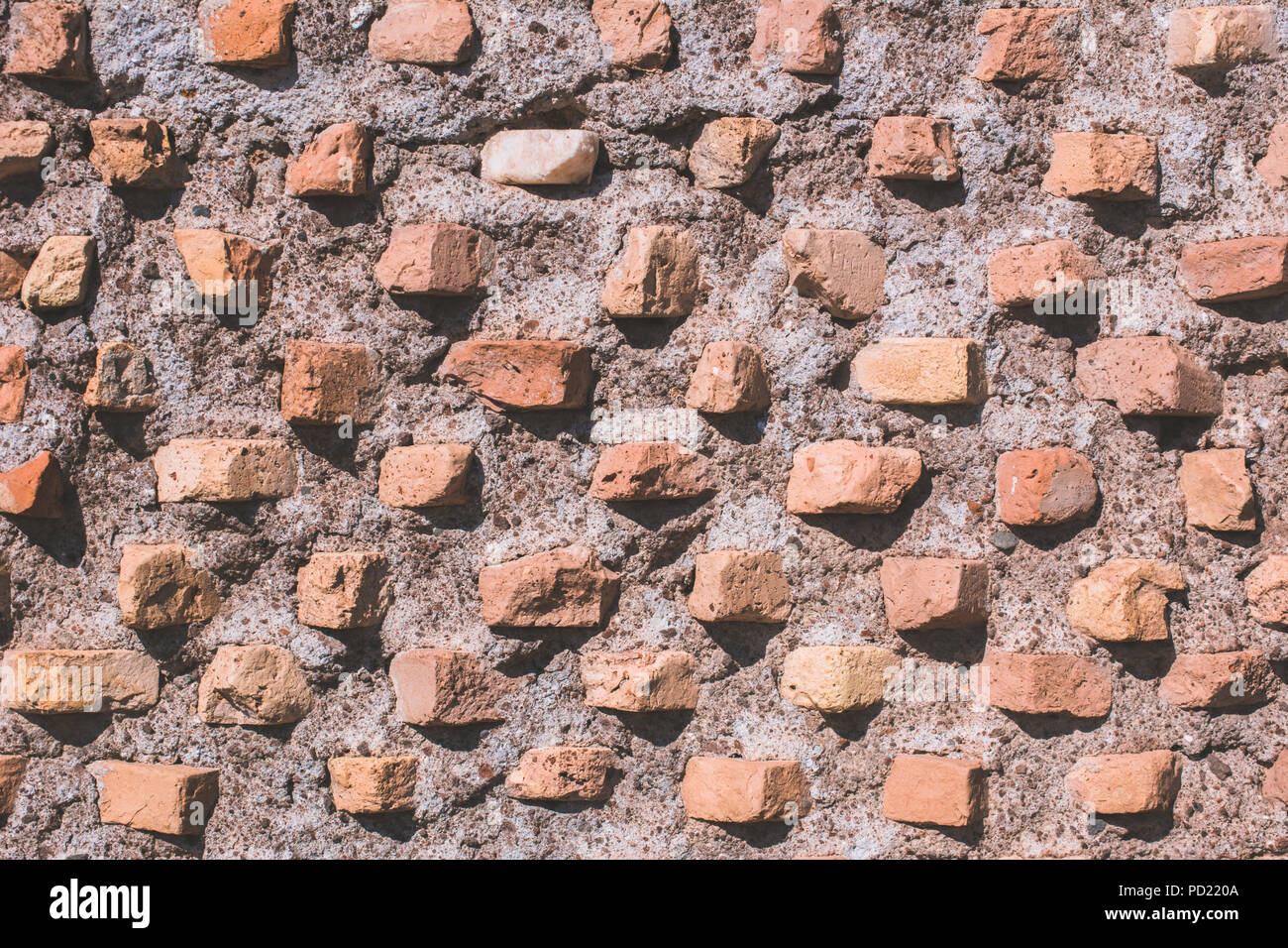 Ancient red bricks stone wall texture background Stock Photo - Alamy