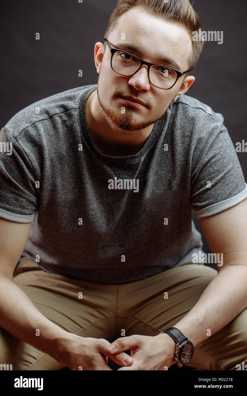 nice kind guy in T-shirt and pants looking at the camera.amiable look ...