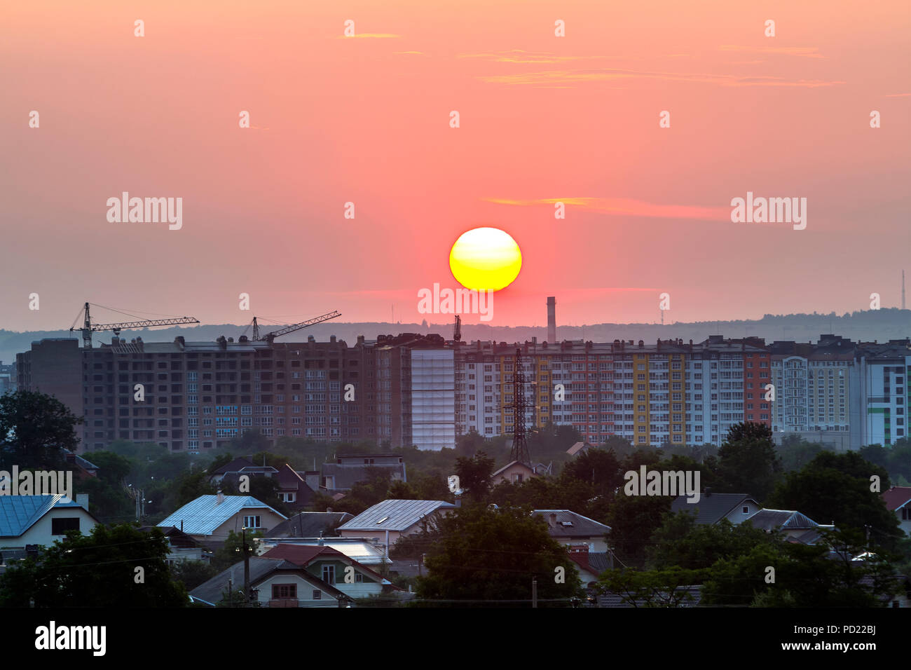 Beautiful sunrise in city suburbs. Big bright white and yellow sun over ...
