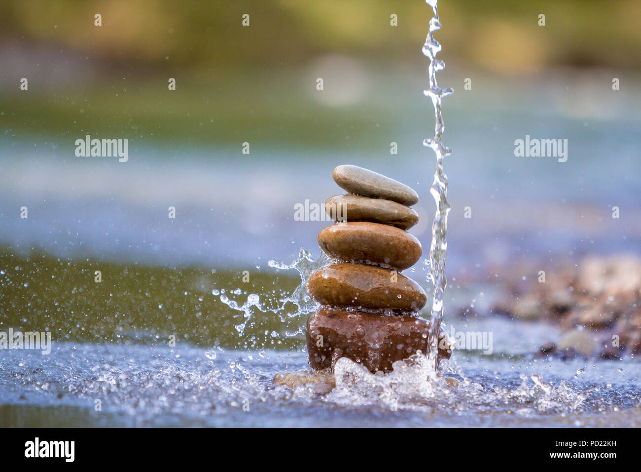 Close-up abstract image of water pouring down on rough natural brown ...