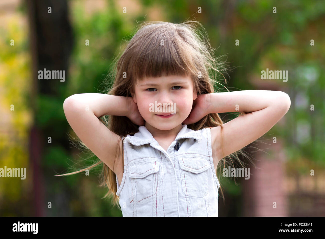 Portrait of a pretty little long-haired blond preschool girl in ...