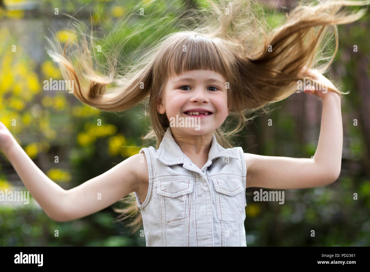 Portrait of a pretty little long-haired blond preschool girl in ...