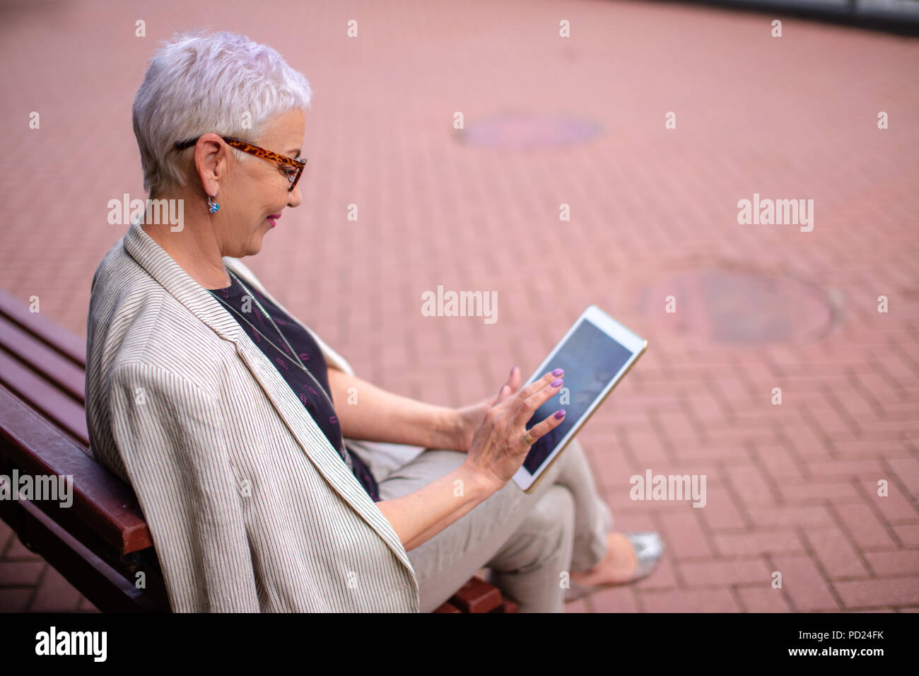 top view photo. a stylish granny is texting message to her grandson ...