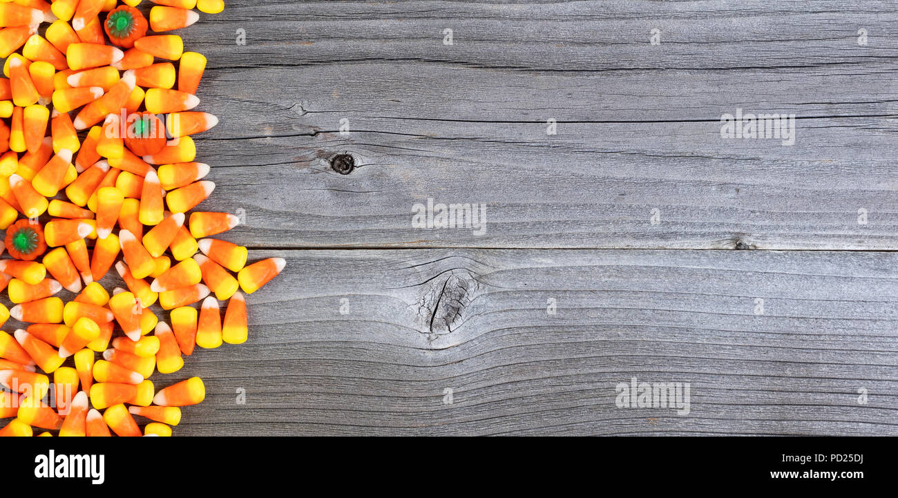 Halloween candy forming left border on weathered wood Stock Photo - Alamy