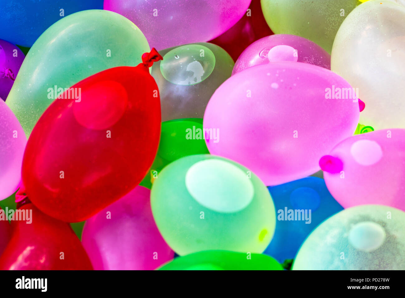 Many bright and colorful water balloons close up Stock Photo - Alamy