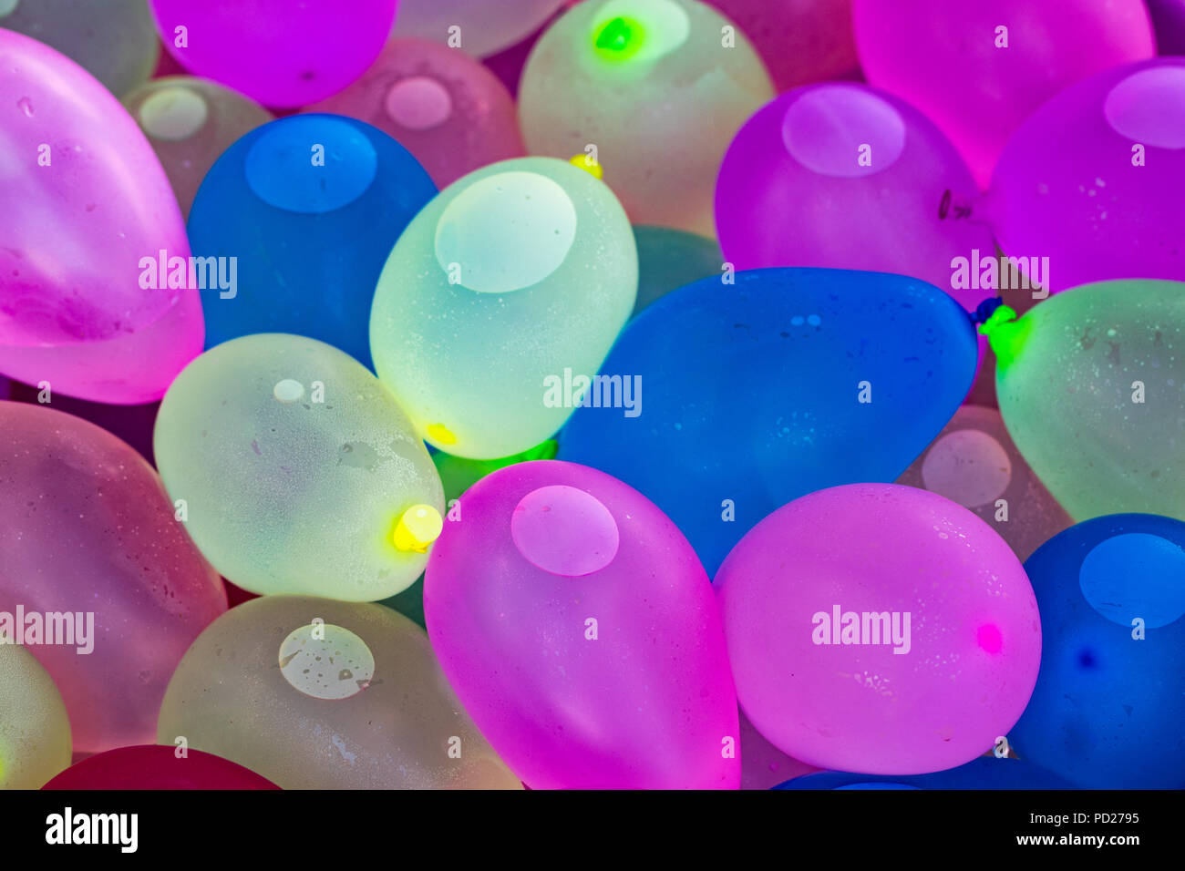 Many bright and colorful water balloons close up Stock Photo - Alamy
