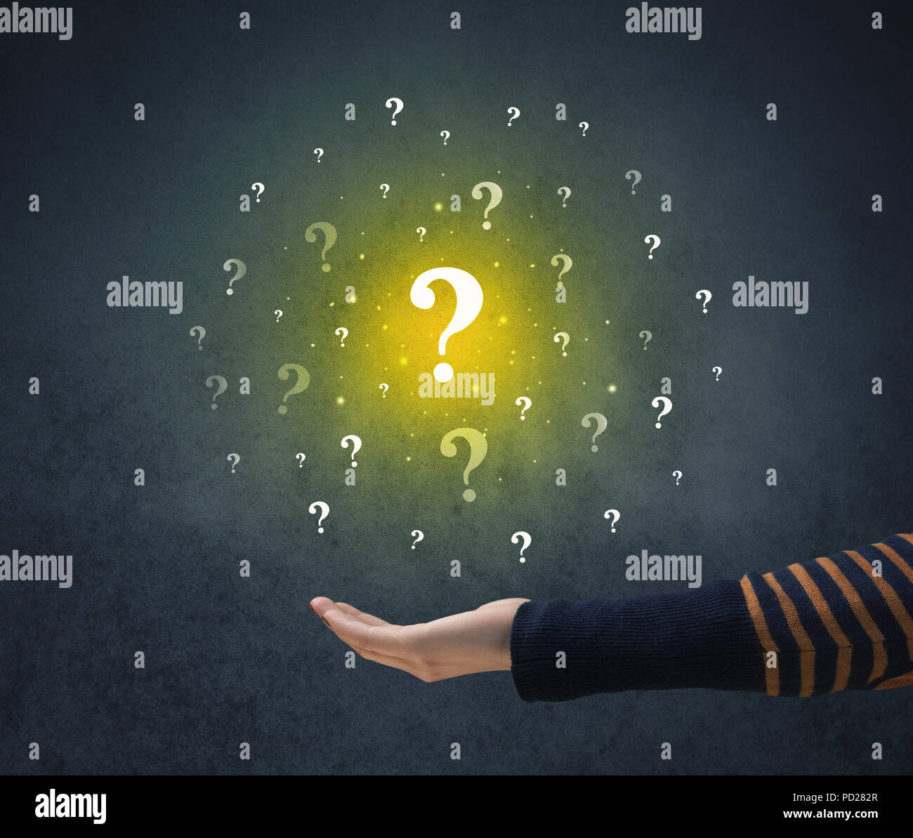Yellow question marks hovering over young hand Stock Photo - Alamy