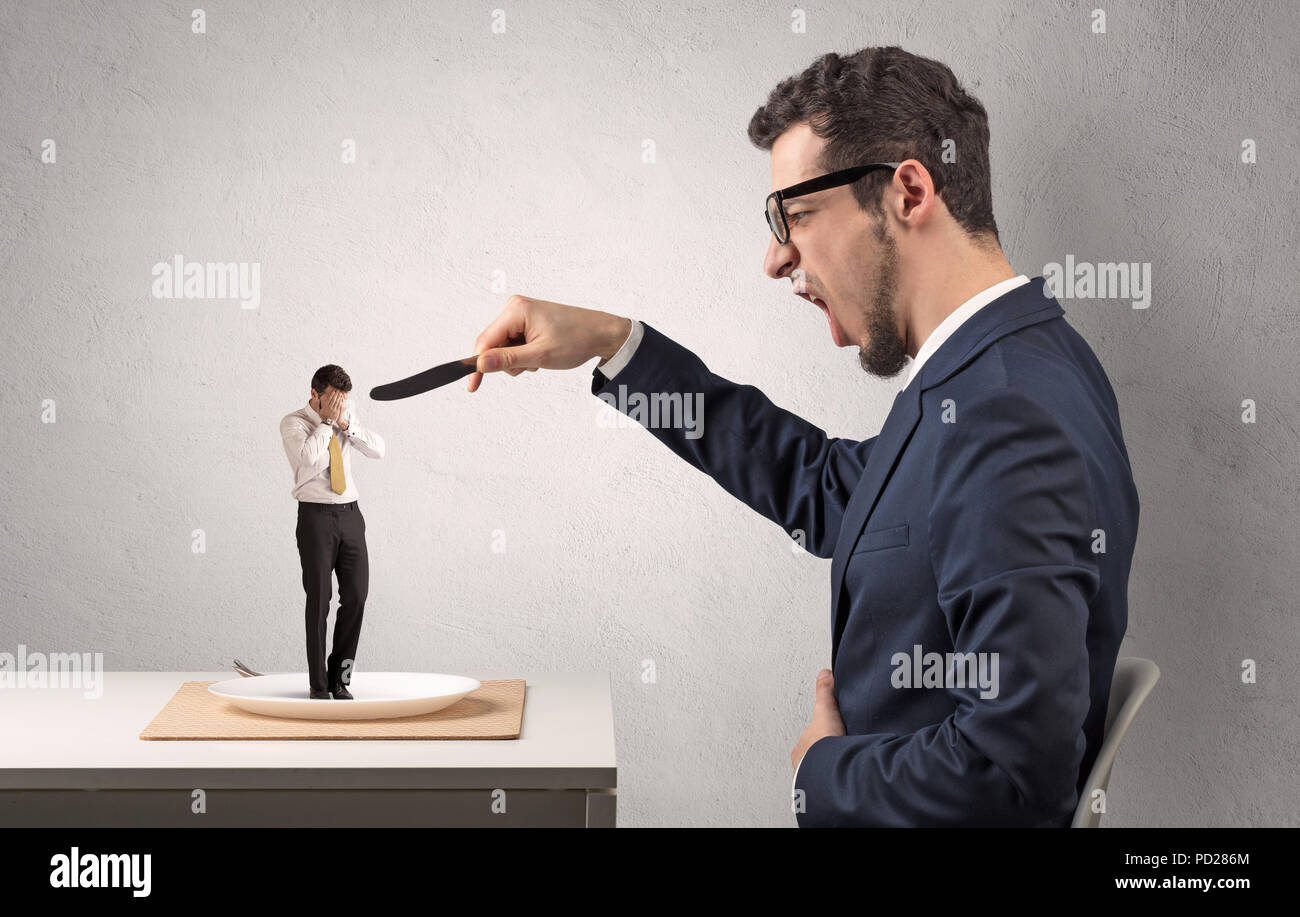 Tiny scared weak businessman almost devoured by great power Stock Photo ...