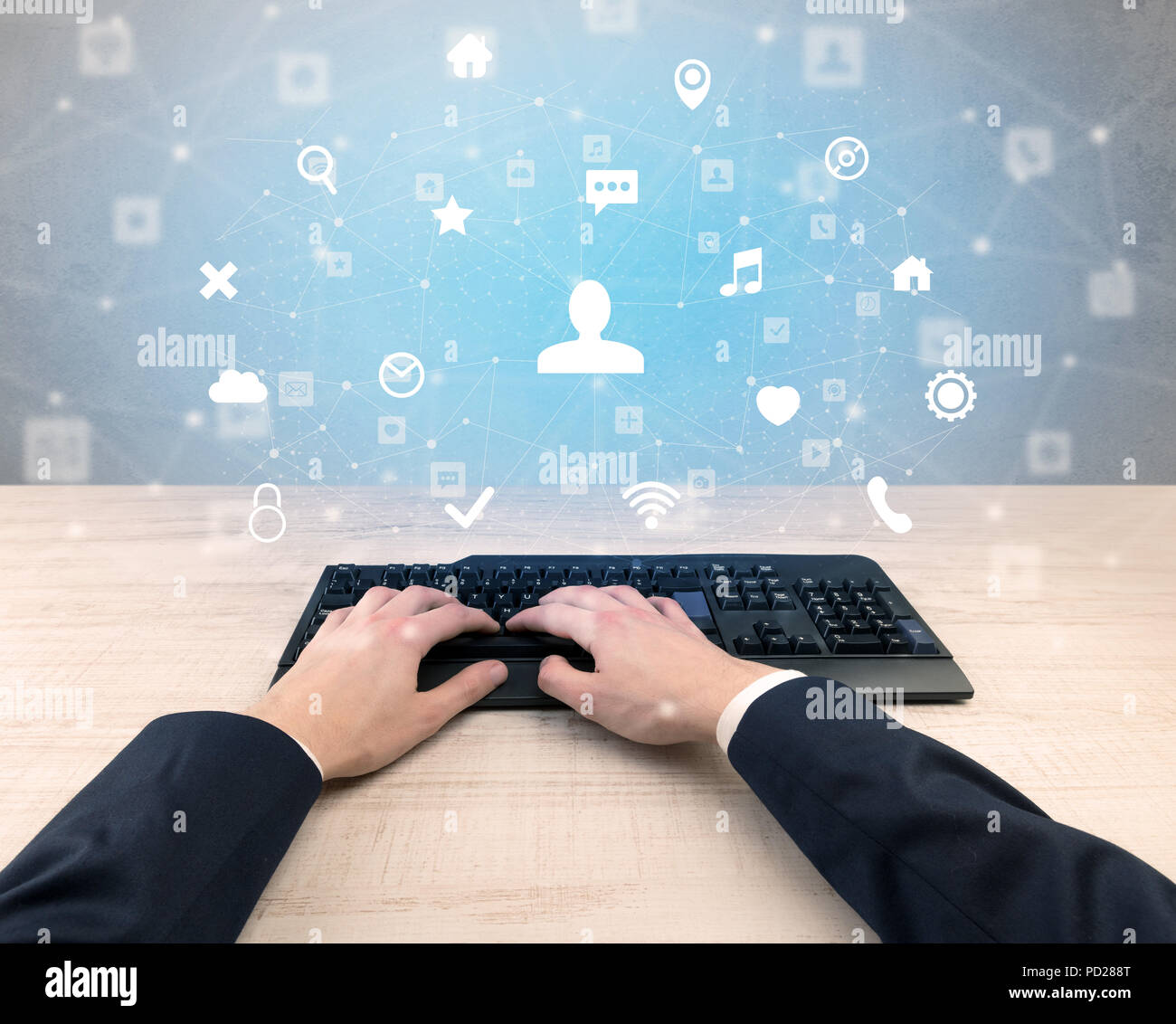 First person view of hand typing with social media concept icons around ...