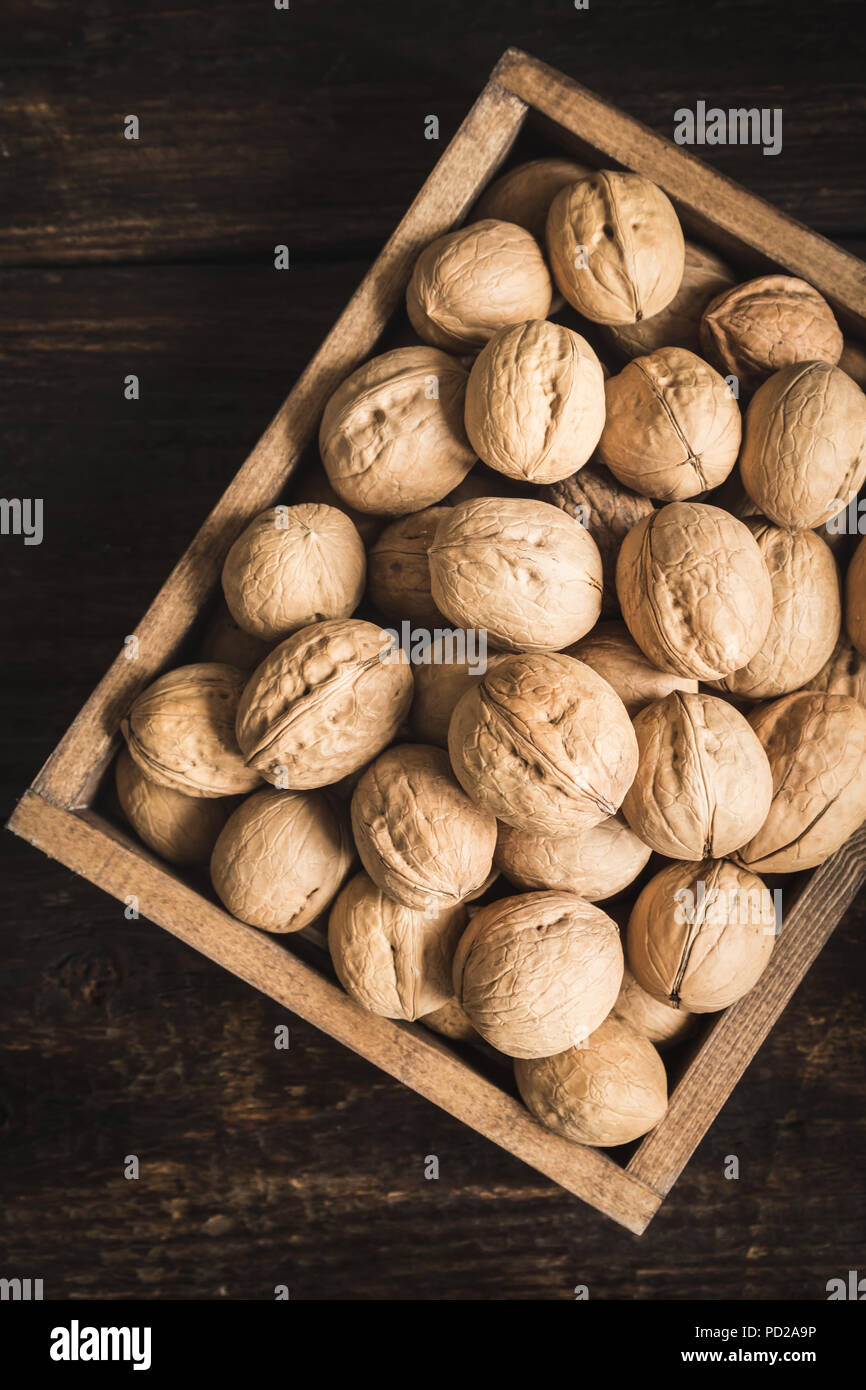 Organic Walnuts in rustic wooden box, top view. Seasonal harvest of ...