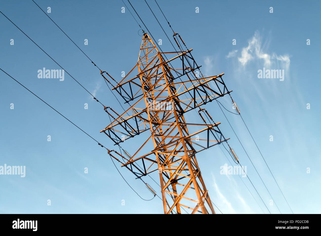 Electric pylon against the backdrop of the blue sky on a summer day ...