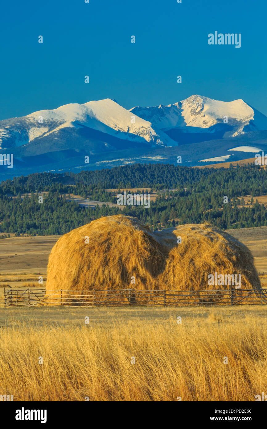 haystacks in fields below peaks of the flint creek range near avon ...