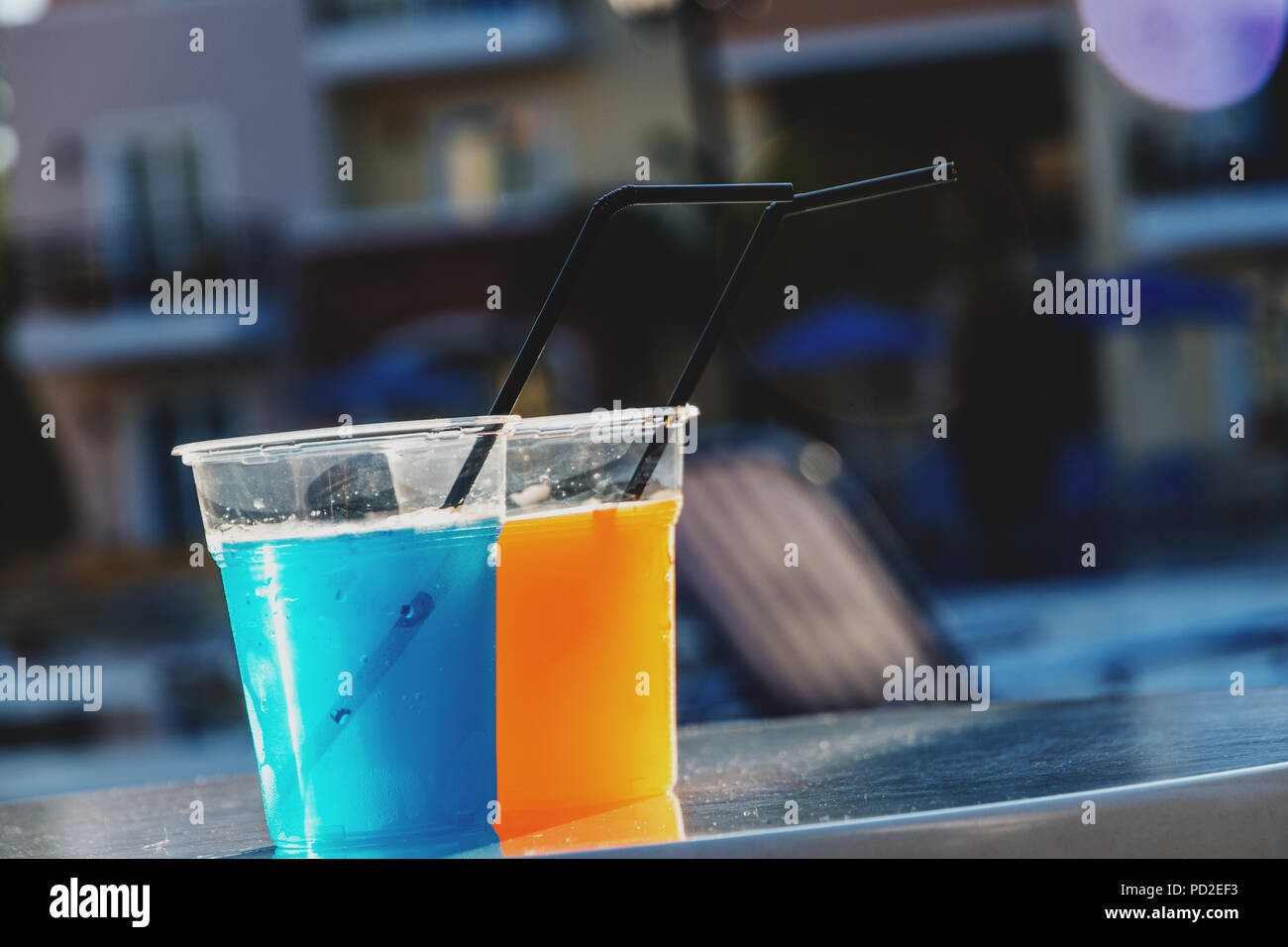 Orange and blue cocktails in plastic bottle in summer Stock Photo - Alamy