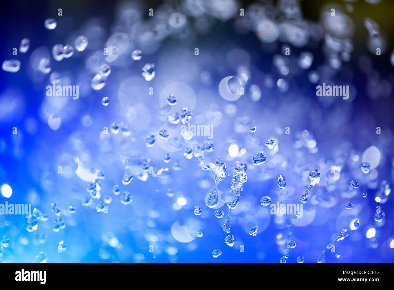 Close up of a water drops on a blue gradient background, covered with ...