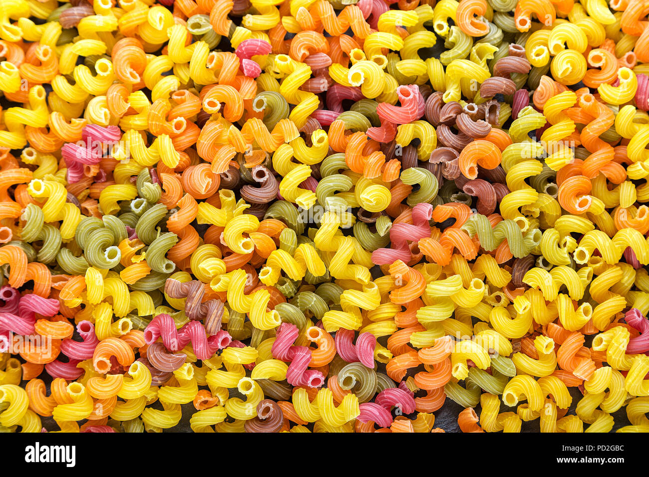 a scattered colored pasta, not cooked, background for recipe Stock ...