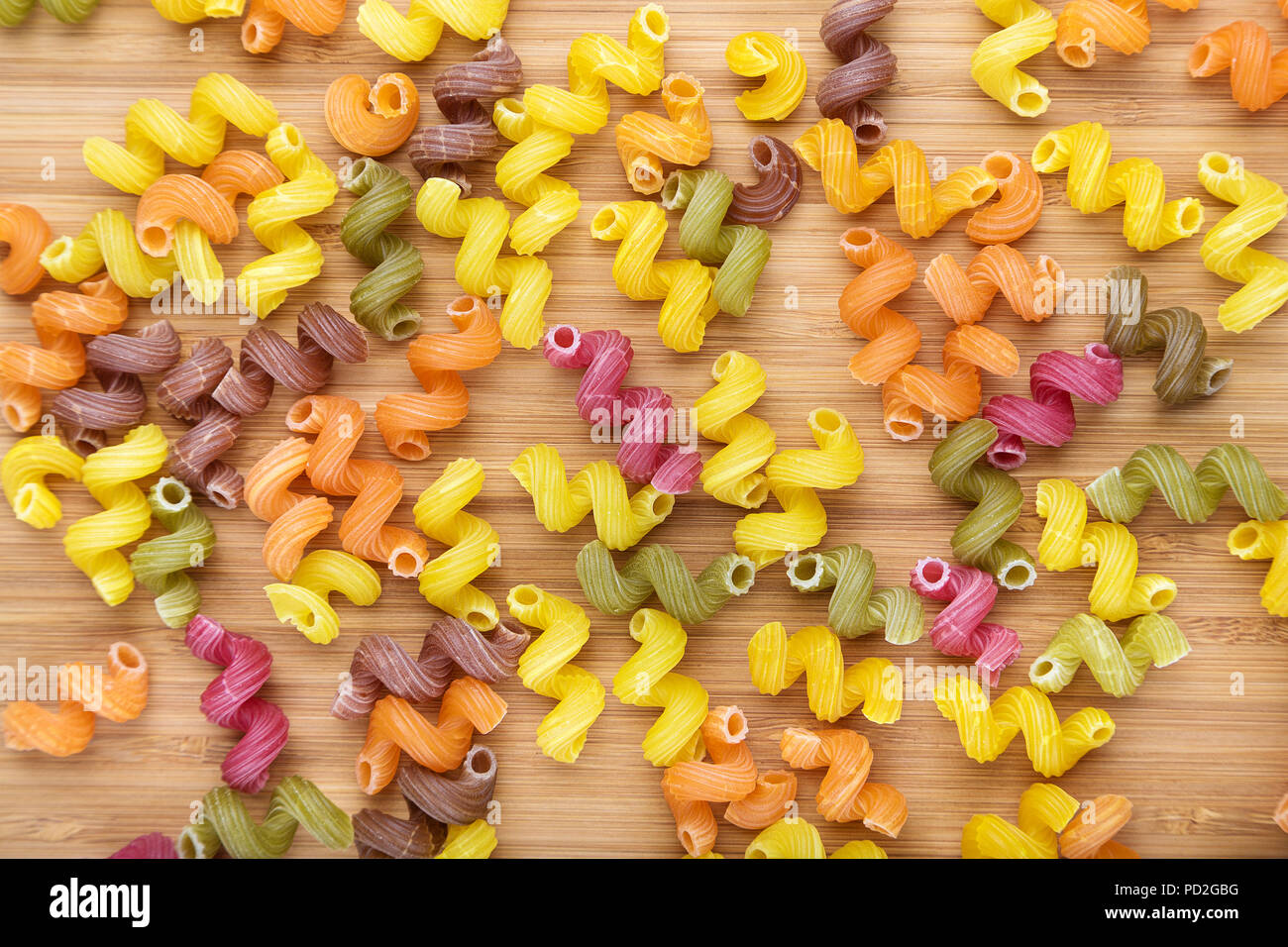 a scattered colored pasta, not cooked, background for recipe Stock ...