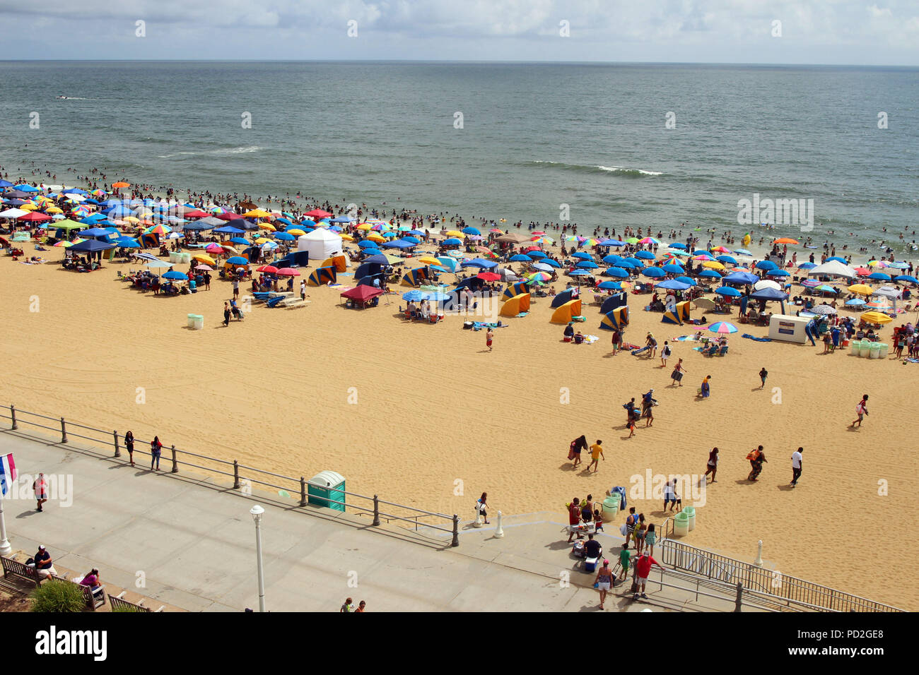 A view of a crowded beach and boardwalk. Virginia Beach on Independence ...