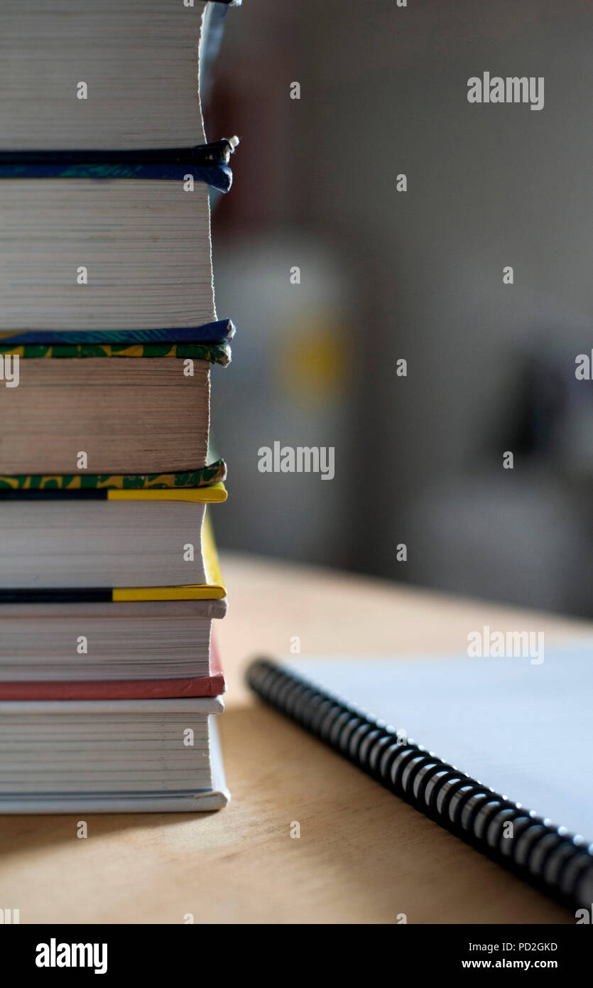 Stack of school books with open spiral notebook Stock Photo - Alamy