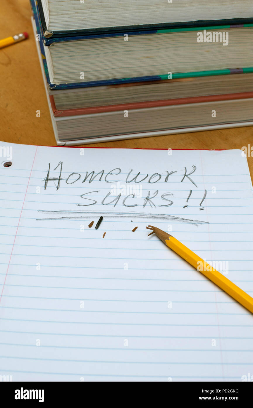 Stack of school books and Homework Sucks in notebook Stock Photo - Alamy