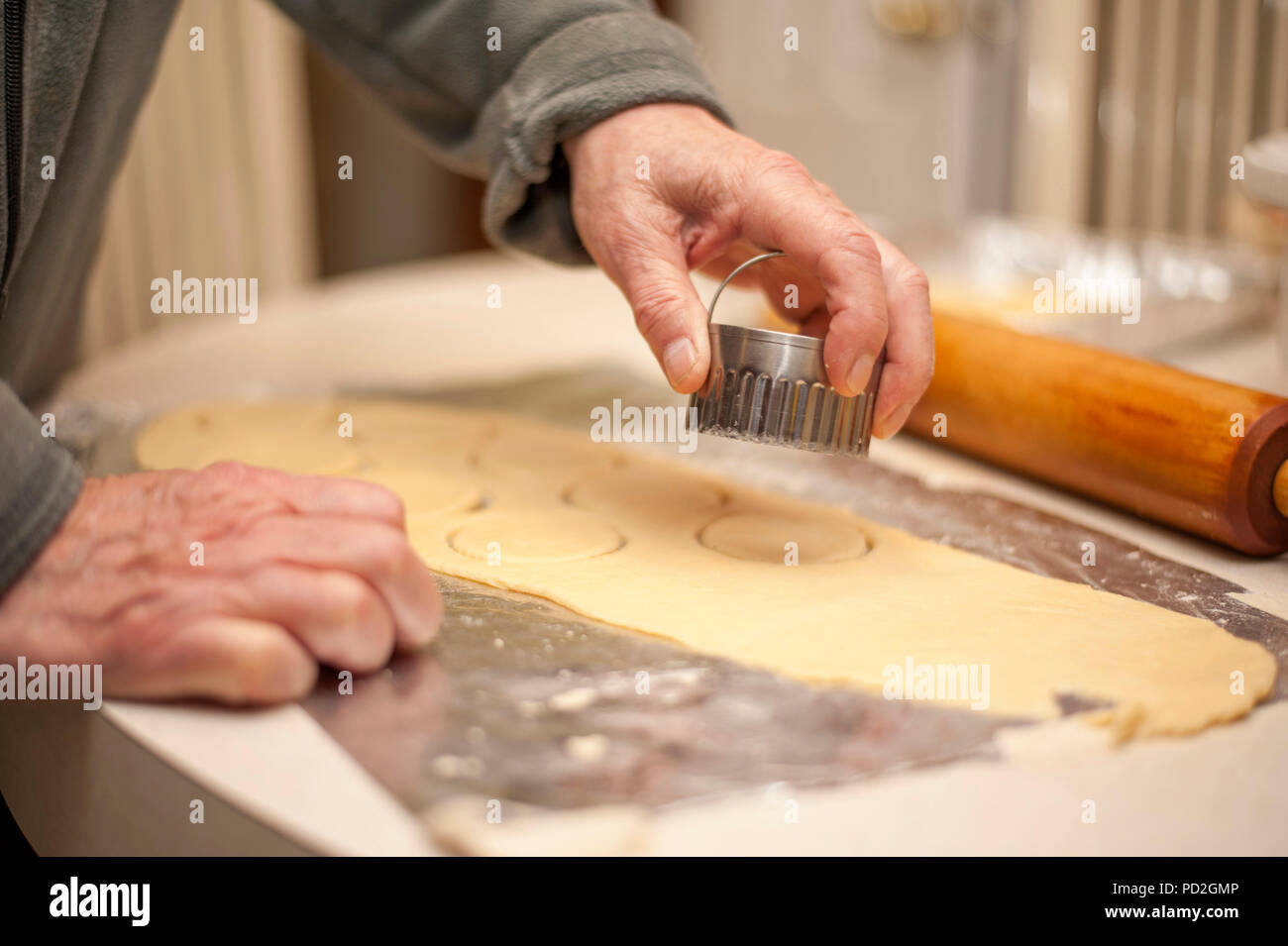 Cutting out cookie dough with cookie cutter Stock Photo - Alamy
