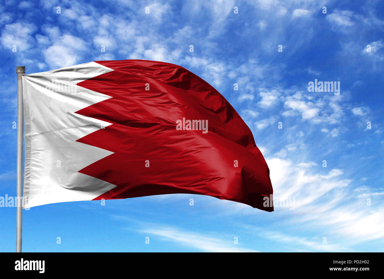 National flag of Bahrain on a flagpole in front of blue sky Stock Photo ...