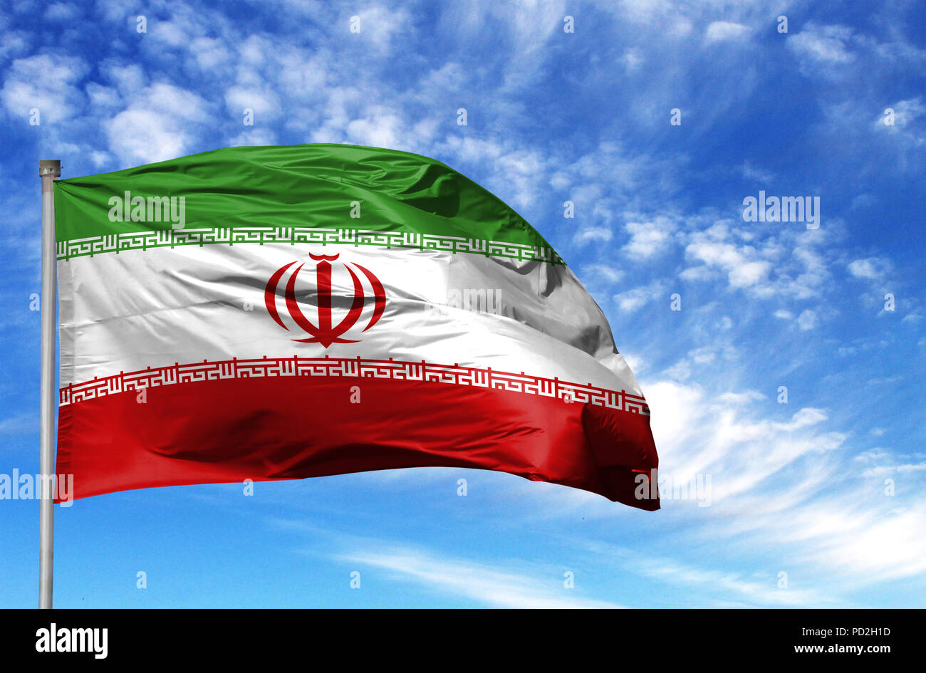 National flag of Iran on a flagpole in front of blue sky Stock Photo ...