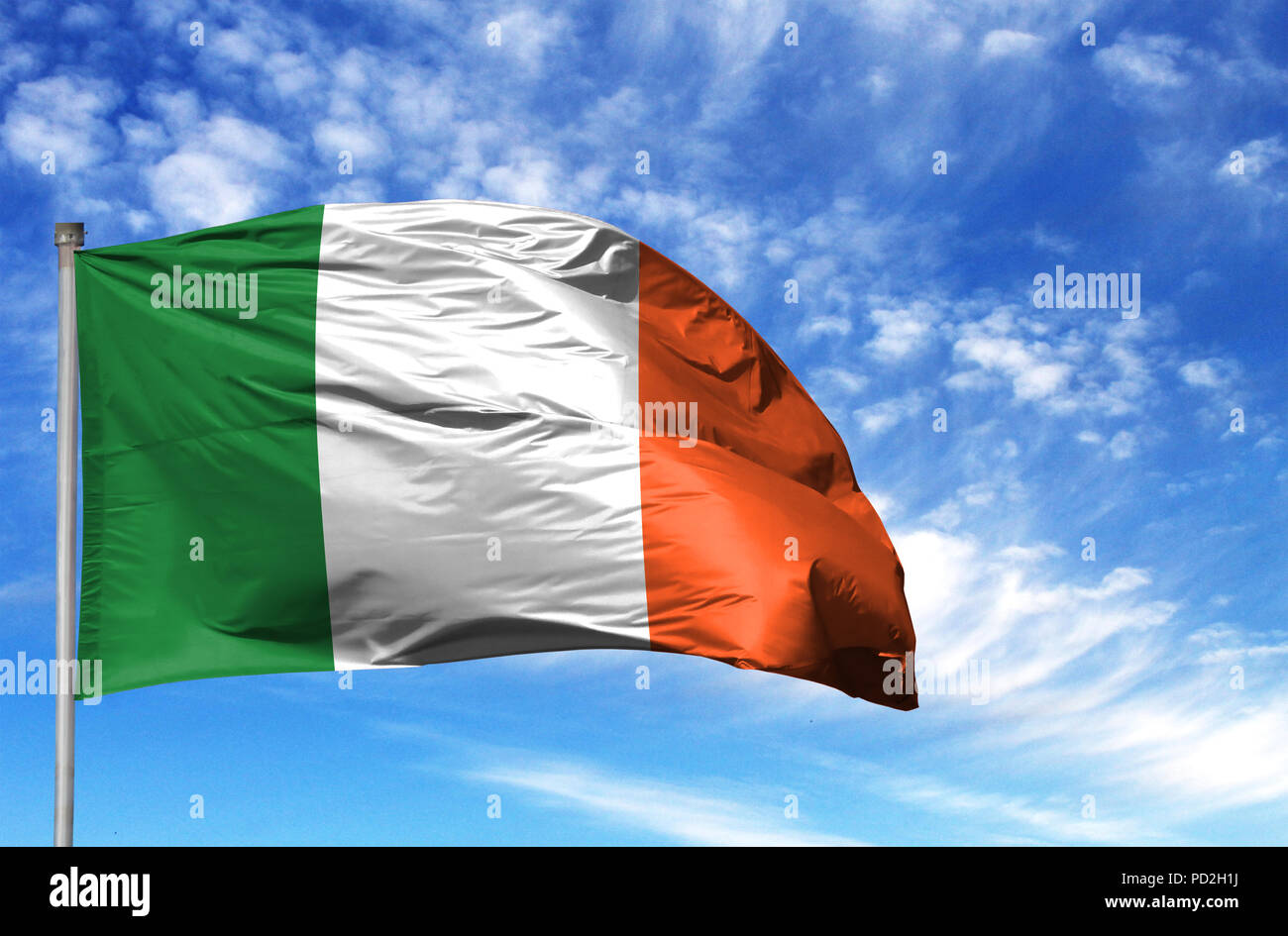 National flag of Ireland on a flagpole in front of blue sky Stock Photo ...