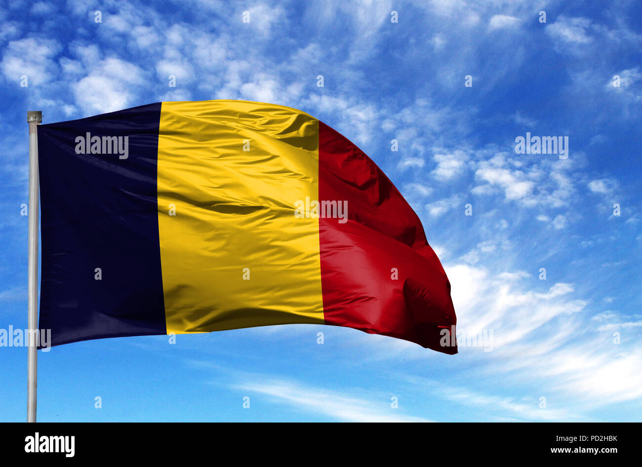 National flag of Chad on a flagpole in front of blue sky Stock Photo ...