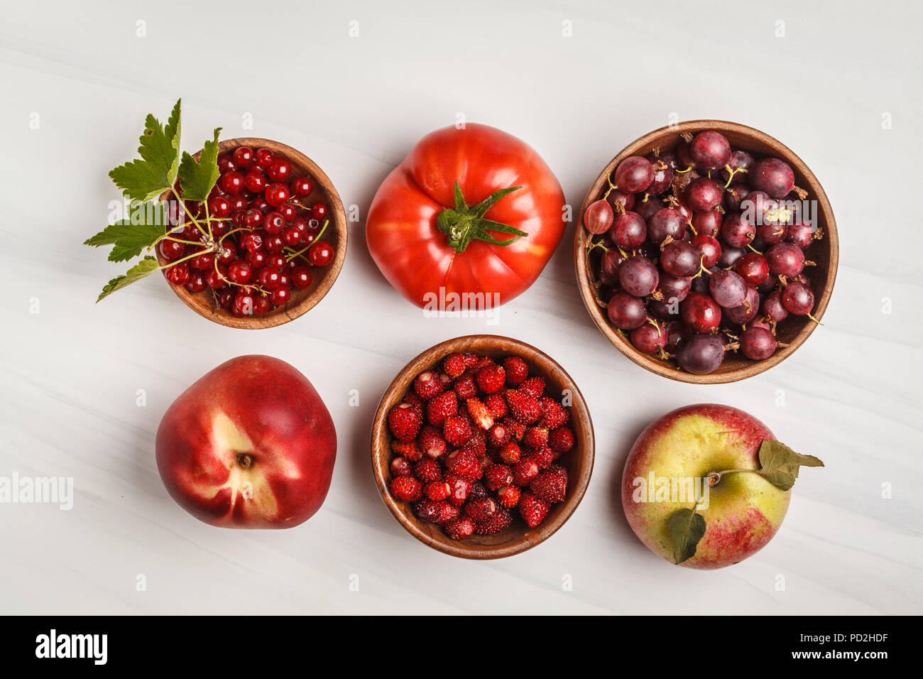 Assortment of red foods on a white background, top view. Fruits and ...