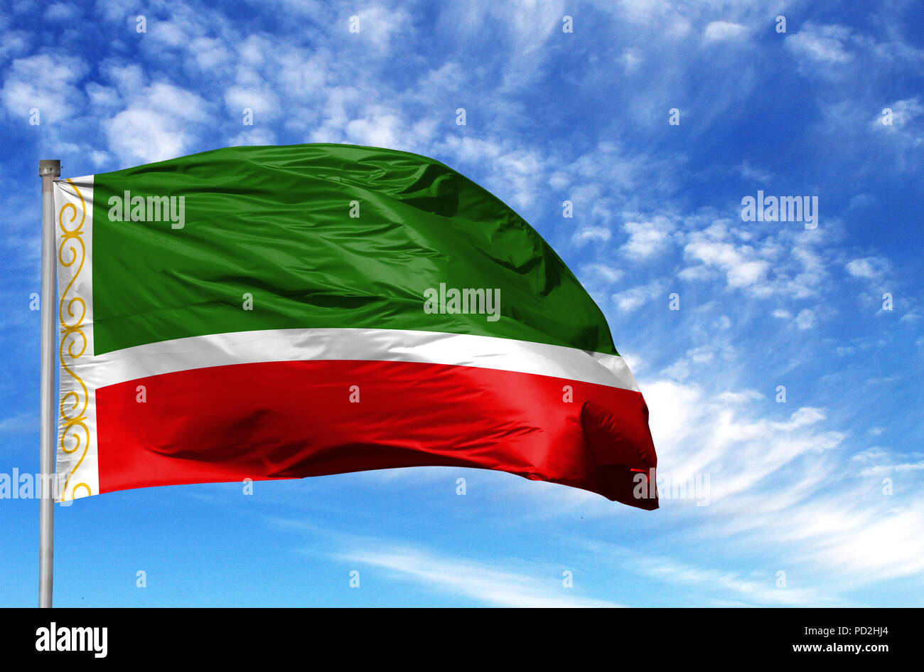 National flag of Chechen Republic on a flagpole in front of blue sky ...