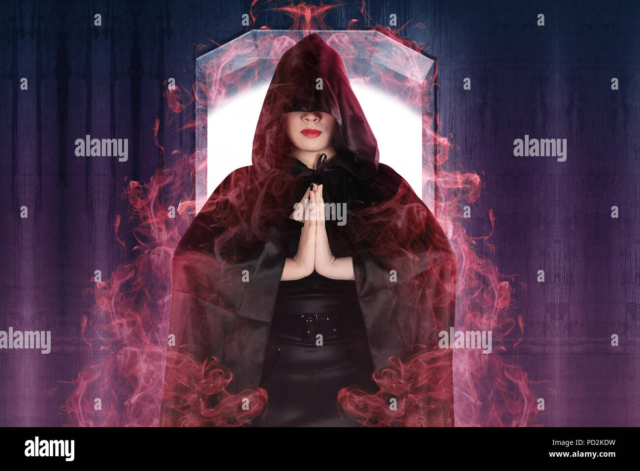 Attractive witch woman showing her magic power with wall background ...