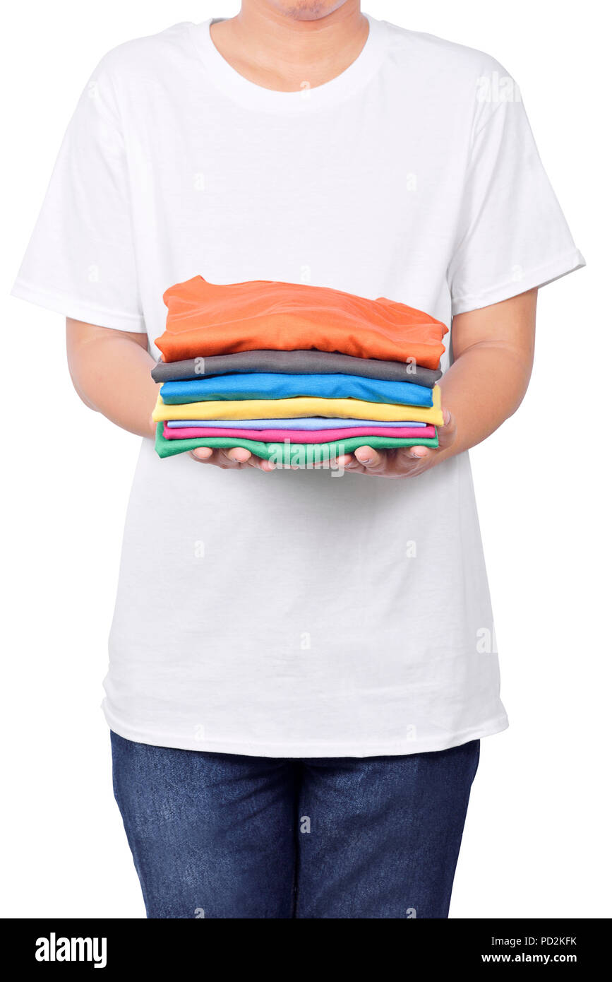 Man holding stack of folded clothes in his hand isolated over white ...