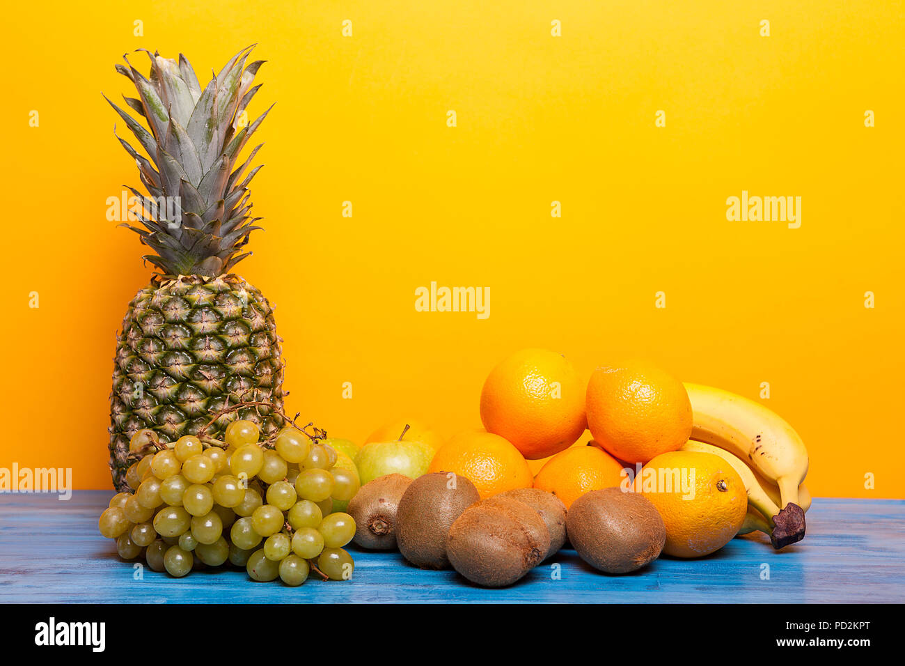 Mixed tasty fruit composition set on yellow background. Fresh healthy ...