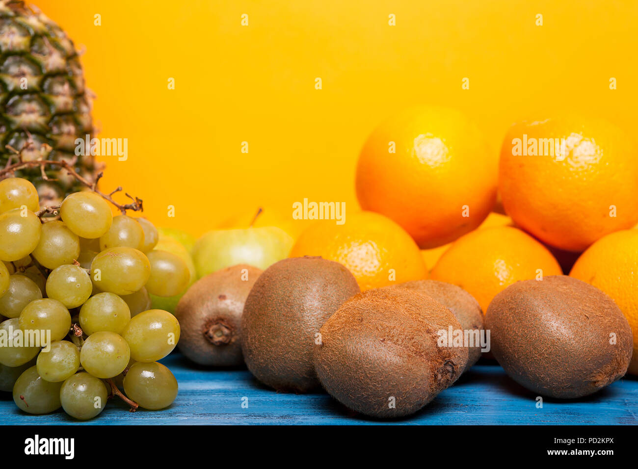 Mixed tasty fruit composition set on yellow background. Gourmet ...