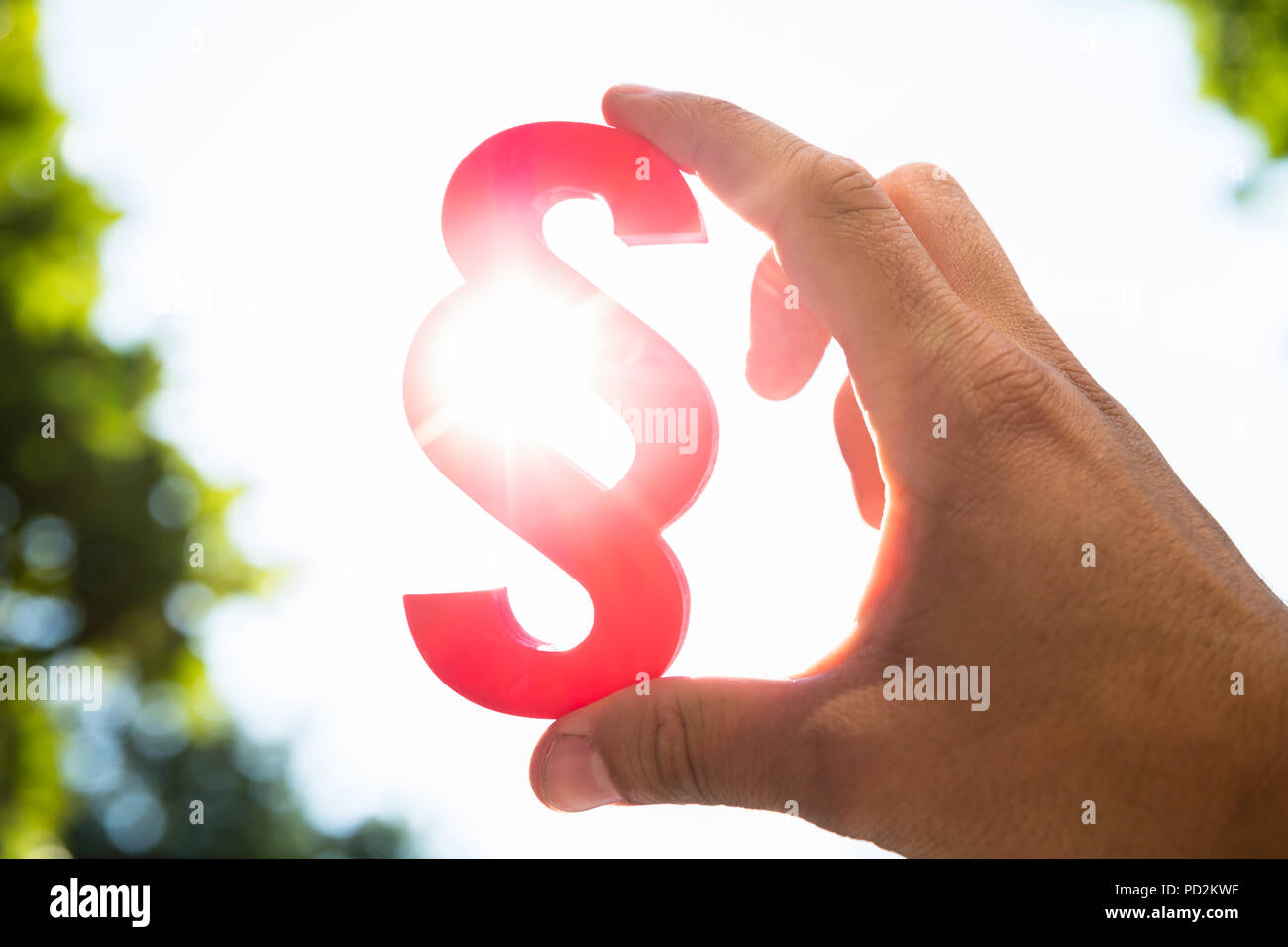 Close-up of a person's hand holding red paragraph symbol Stock Photo ...